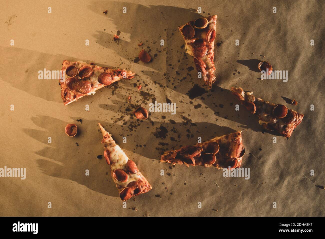 Messy Slices of Pepperoni Pizza on a tabletop Stock Photo - Alamy