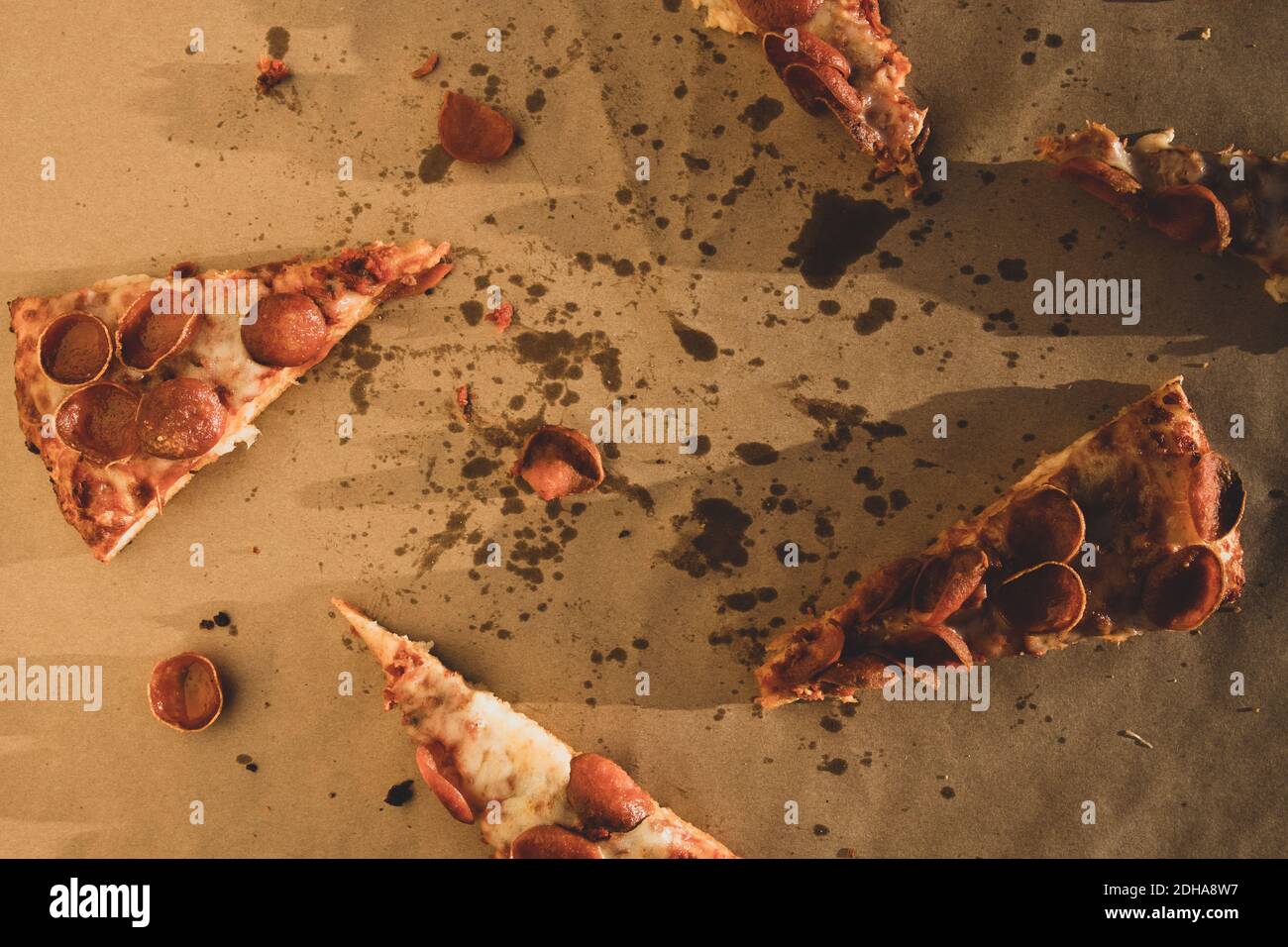 Messy Slices of Pepperoni Pizza on a tabletop Stock Photo - Alamy