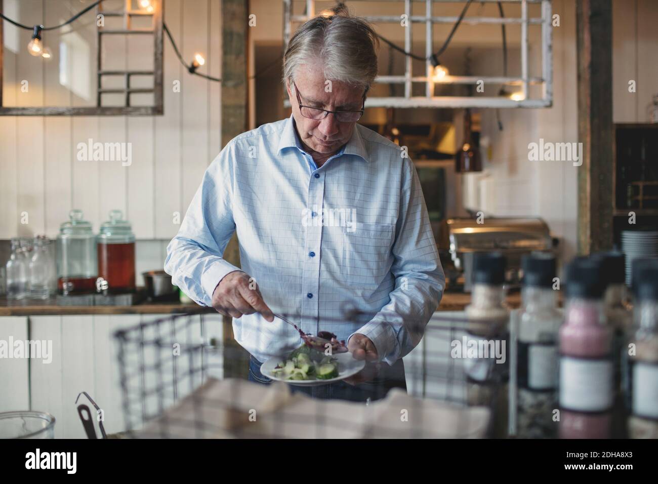 Senior man taking food in plate at buffet counter Stock Photo - Alamy