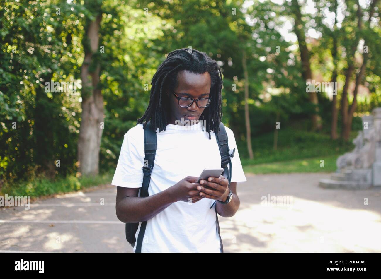 Young university student using mobile phone outside university Stock ...