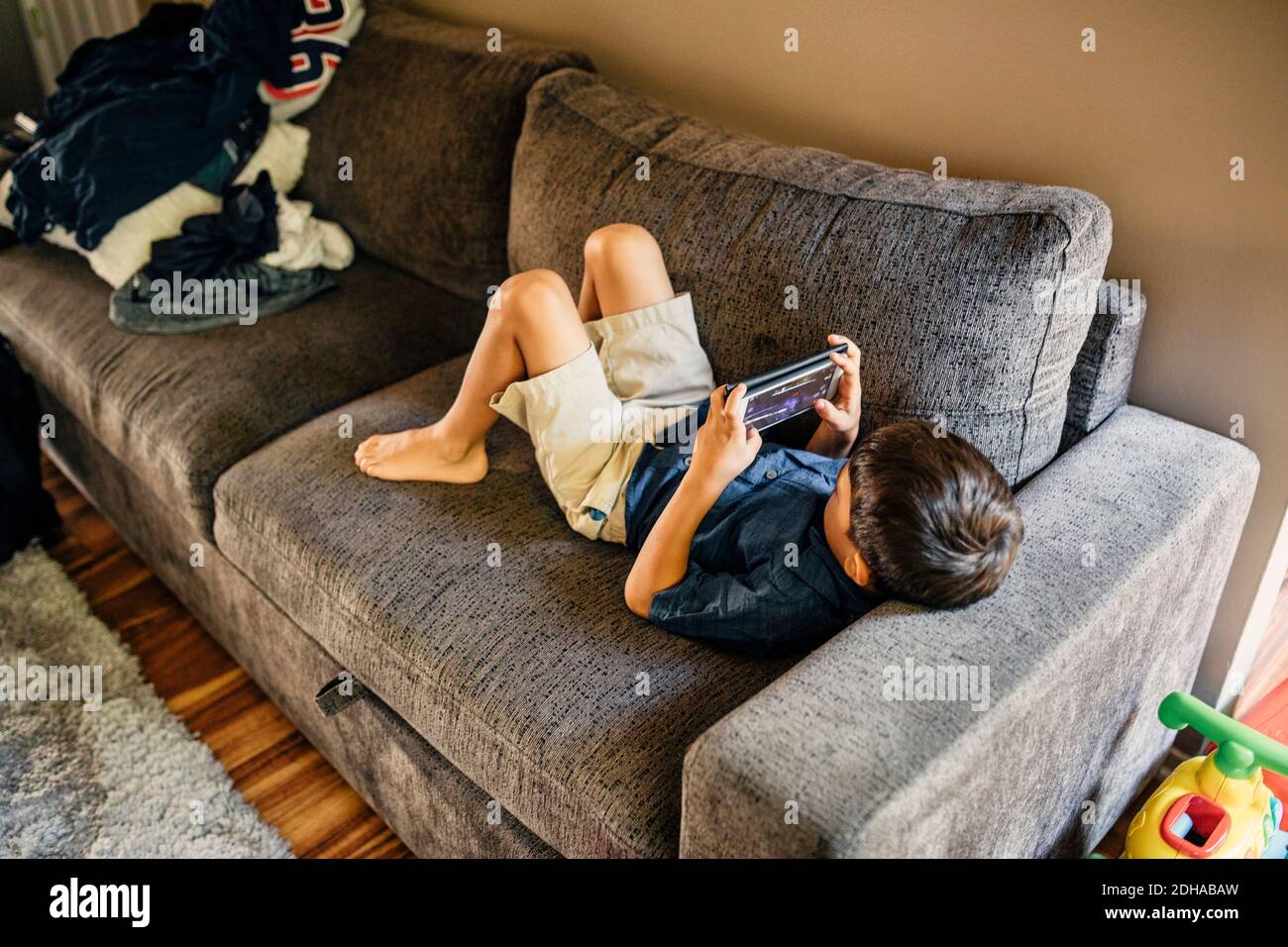 Boy playing with phone hi-res stock photography and images - Alamy