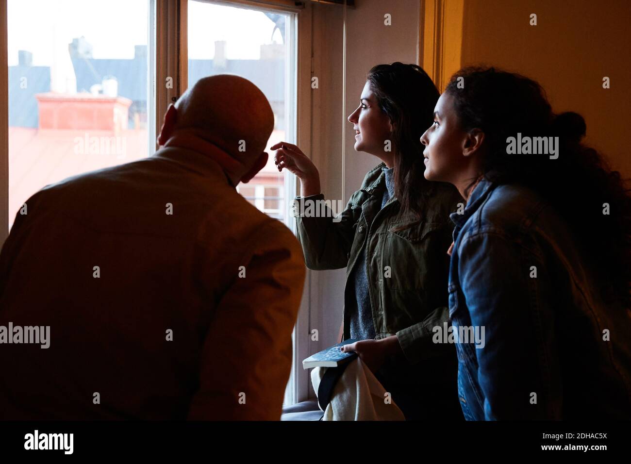 Women looking through window hi-res stock photography and images - Alamy