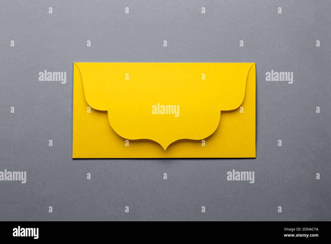 Yellow closed envelope on gray paper background Stock Photo - Alamy
