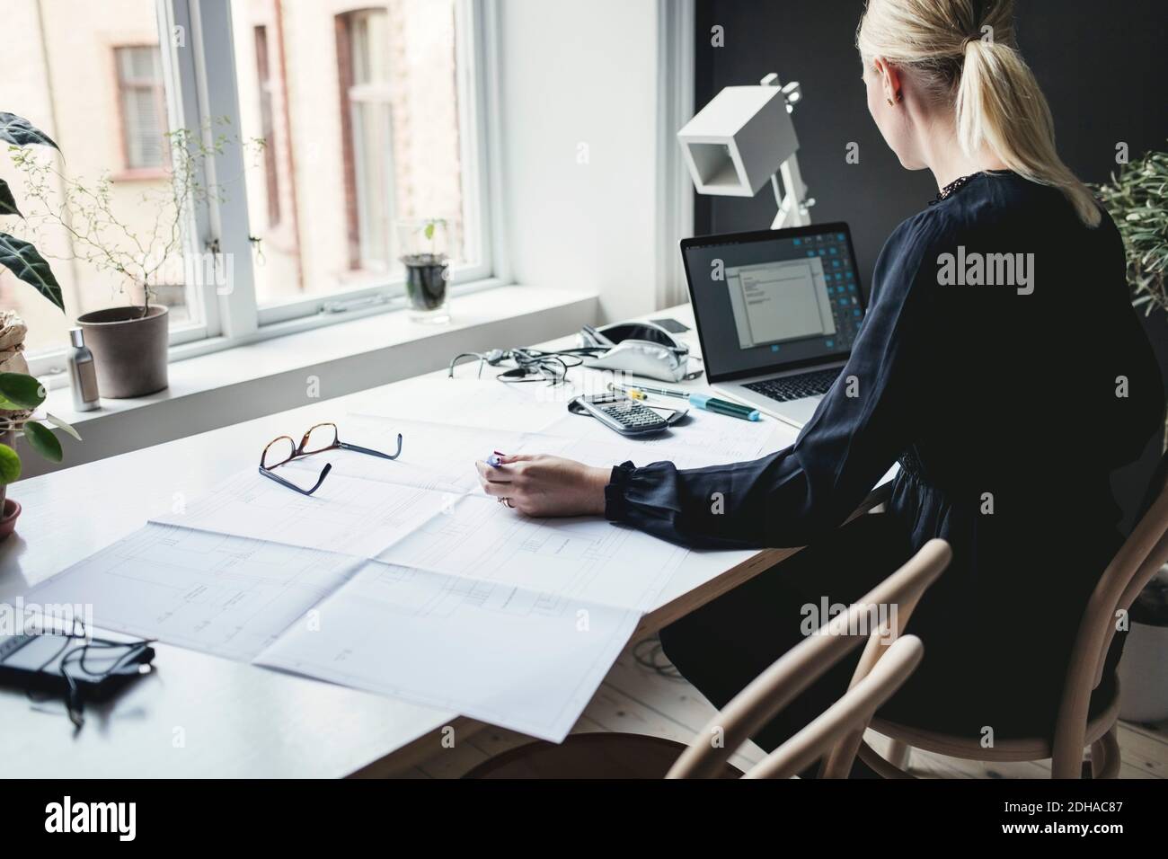 Female engineer working on desk at home office Stock Photo - Alamy