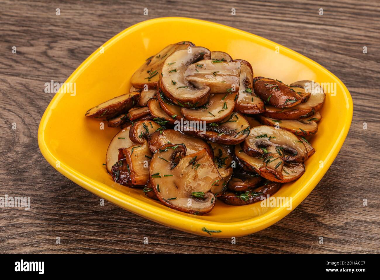 Roasted champignon with herbs and spices in the bowl Stock Photo - Alamy