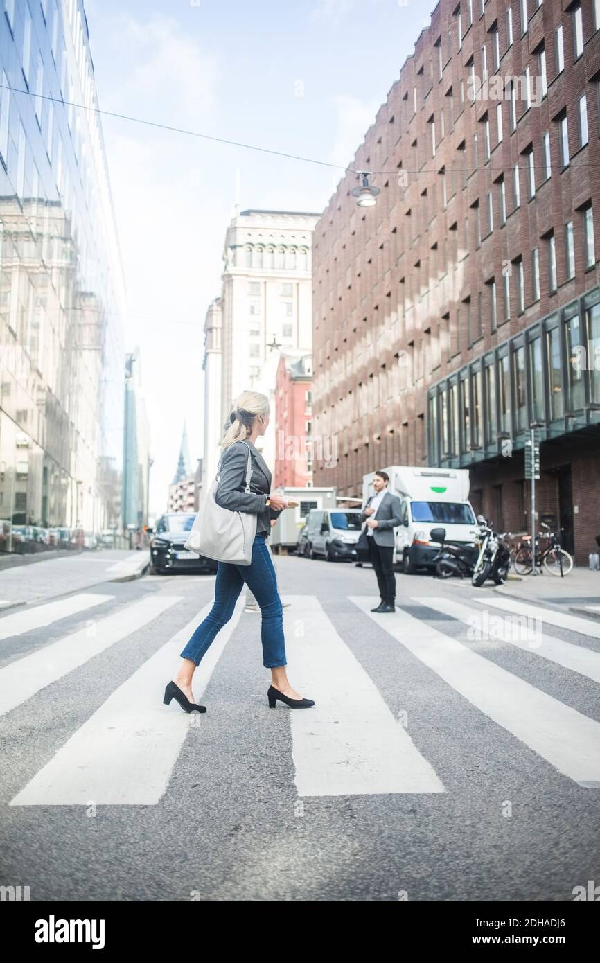 Two women crossing the road hi-res stock photography and images - Alamy