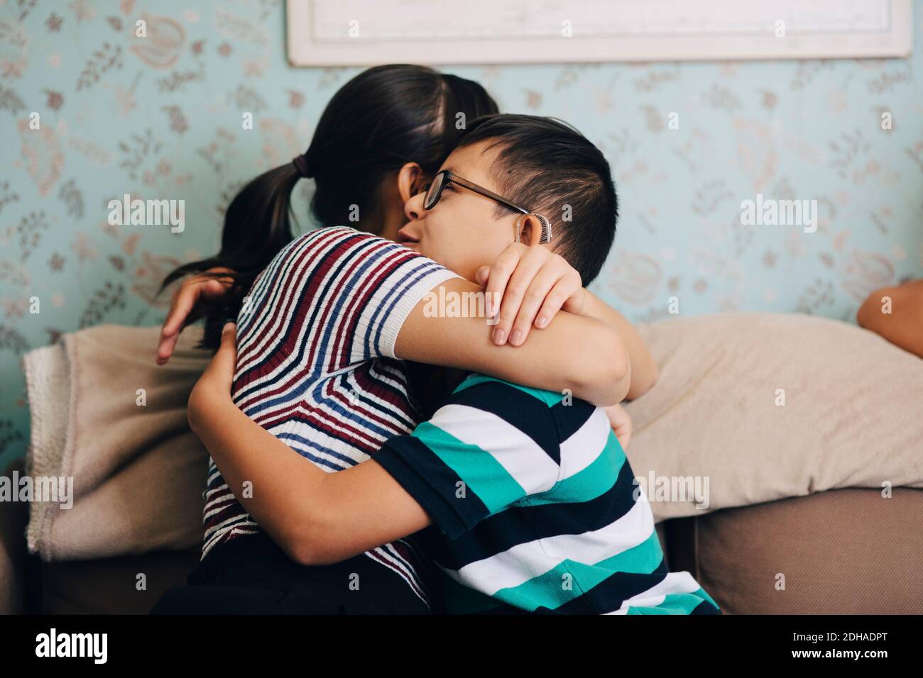 Brother sister cuddling hi-res stock photography and images - Alamy