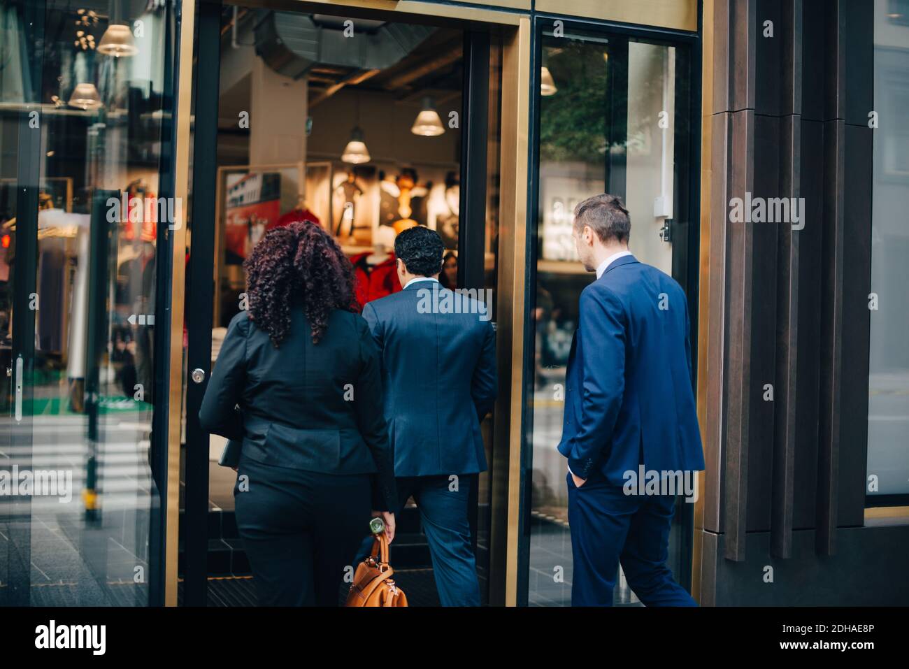 Rear view of business colleagues entering cafe in city Stock Photo - Alamy