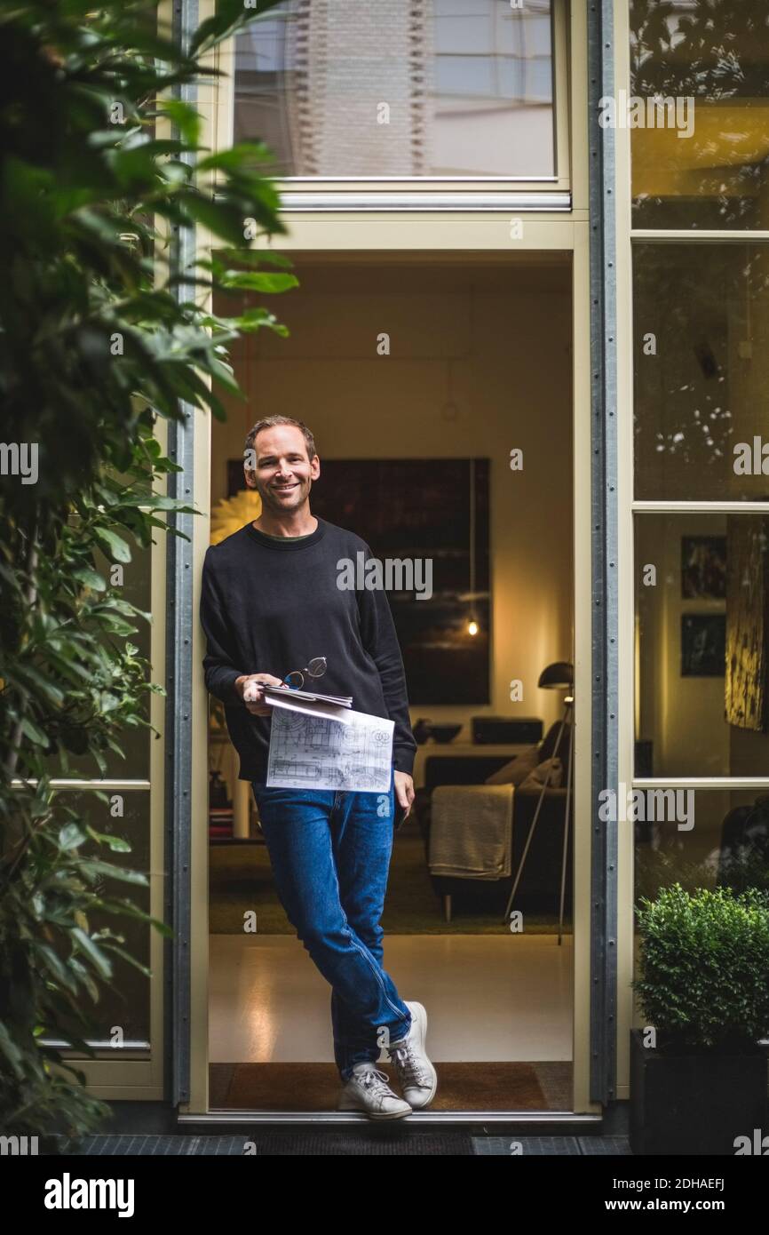 Portrait of male architect standing in house doorway Stock Photo - Alamy