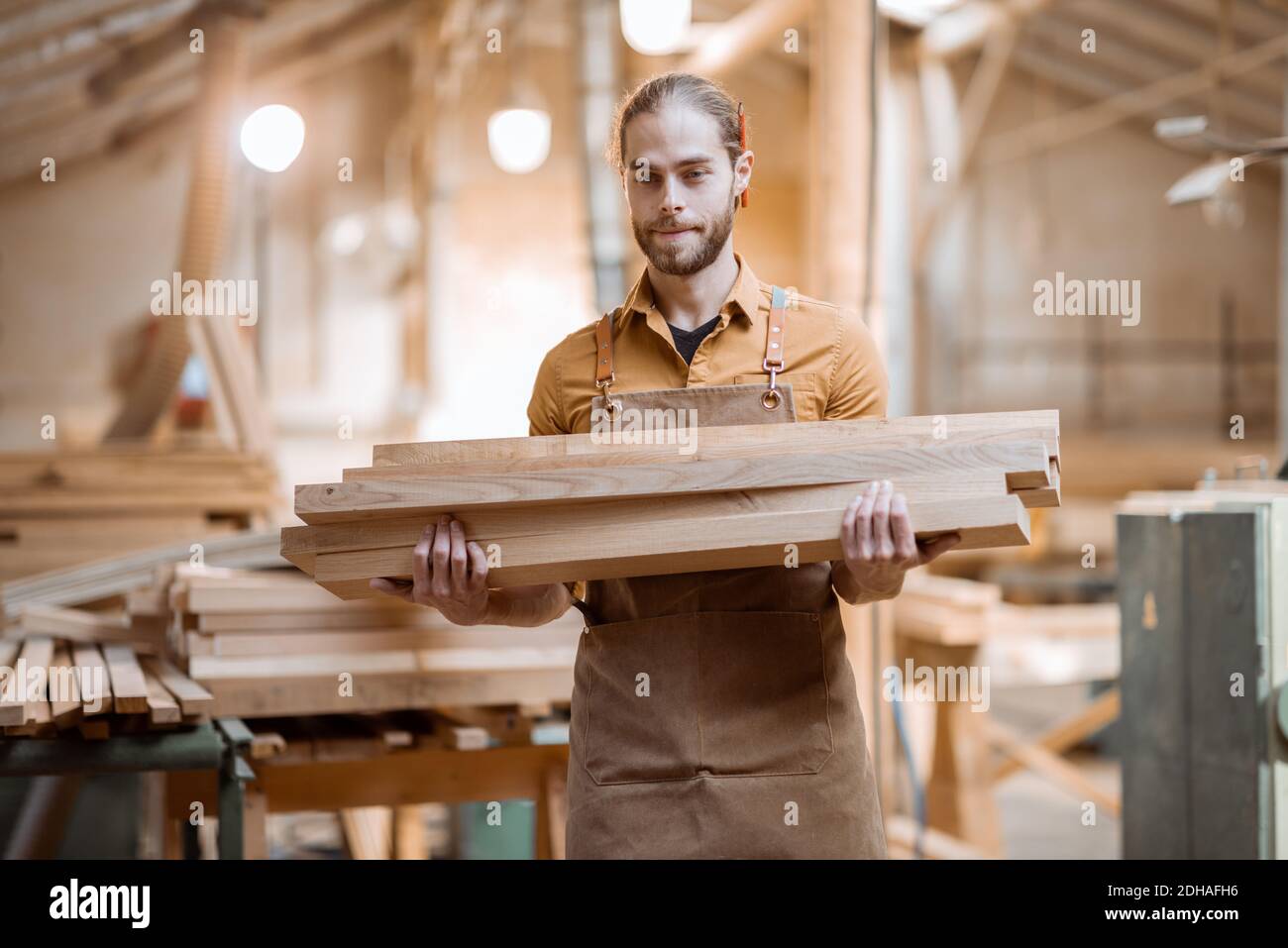 Man carrying planks of wood hi-res stock photography and images - Alamy