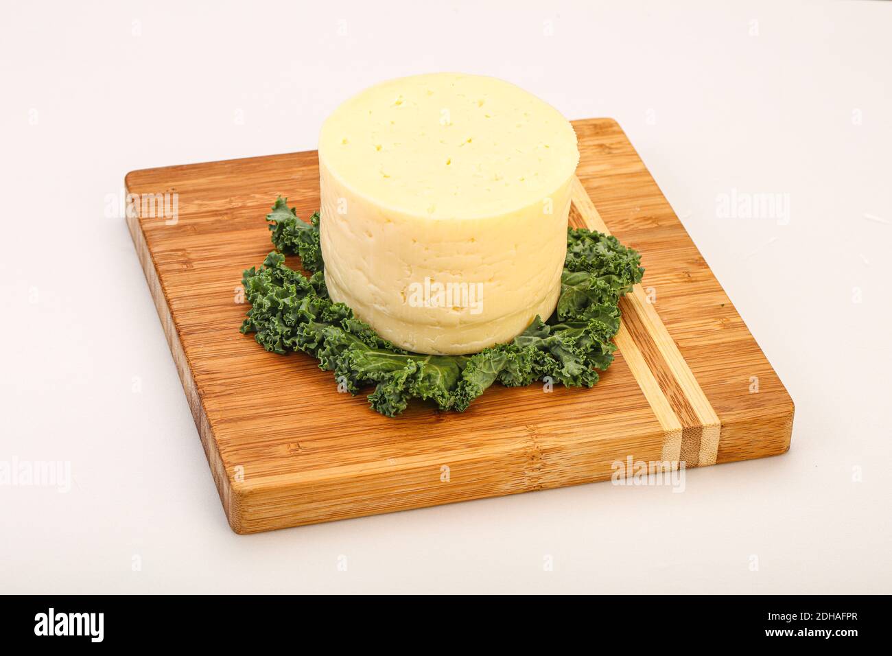 Yellow round dairy soft cheese piece Stock Photo - Alamy