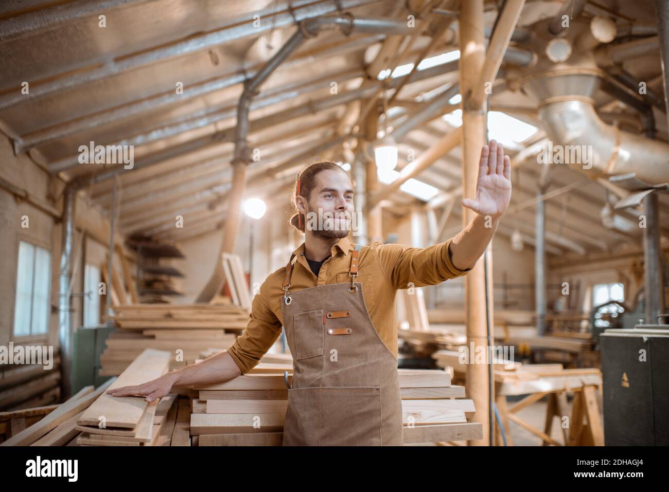Handsome carpenter designing some woodwork at the workshop. Concept of ...