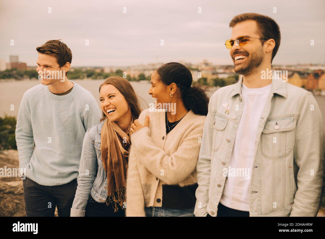Happy male and female friends standing on rock formation Stock Photo ...