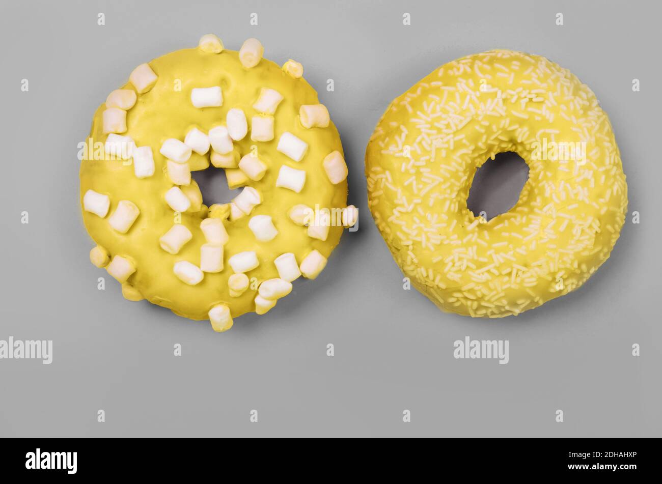 Colors of year 2021. Gray and Yellow. Two donuts with icing on pastel ...