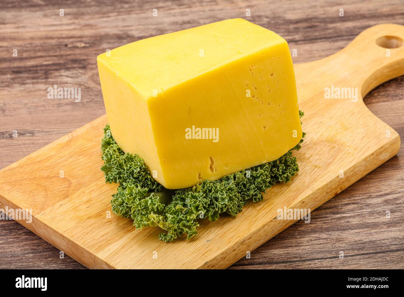 Yellow tilsiter cheese dairy product brick Stock Photo - Alamy