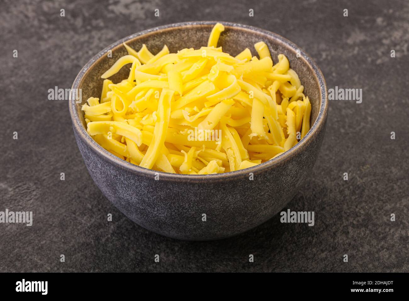 Shredded yellow cheese in the bowl for cooking Stock Photo - Alamy