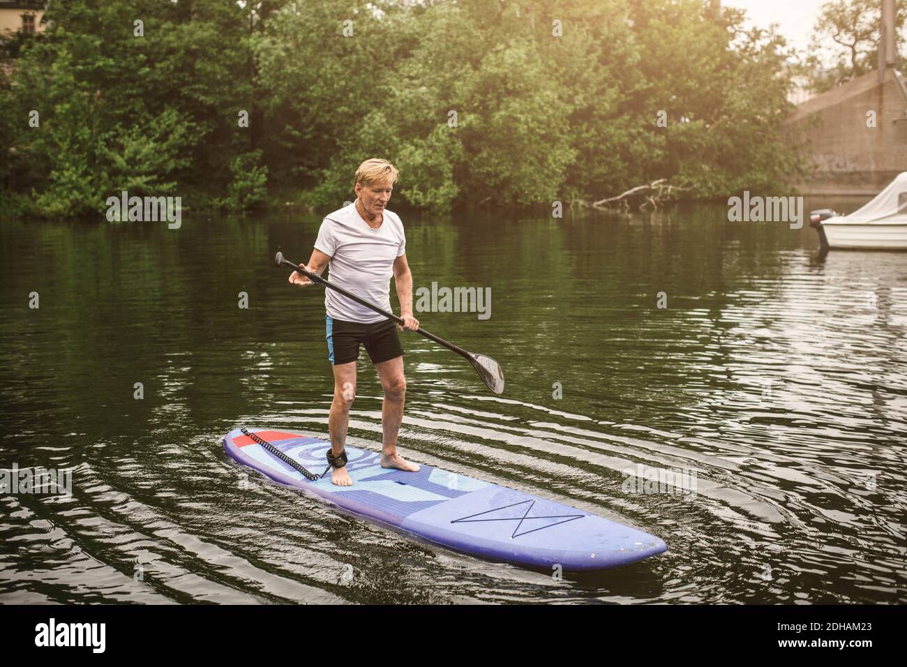 Senior man paddleboarding hi-res stock photography and images - Alamy
