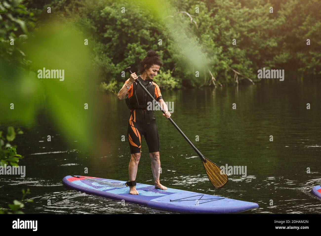 Stand up paddleboarding woman hi-res stock photography and images - Alamy