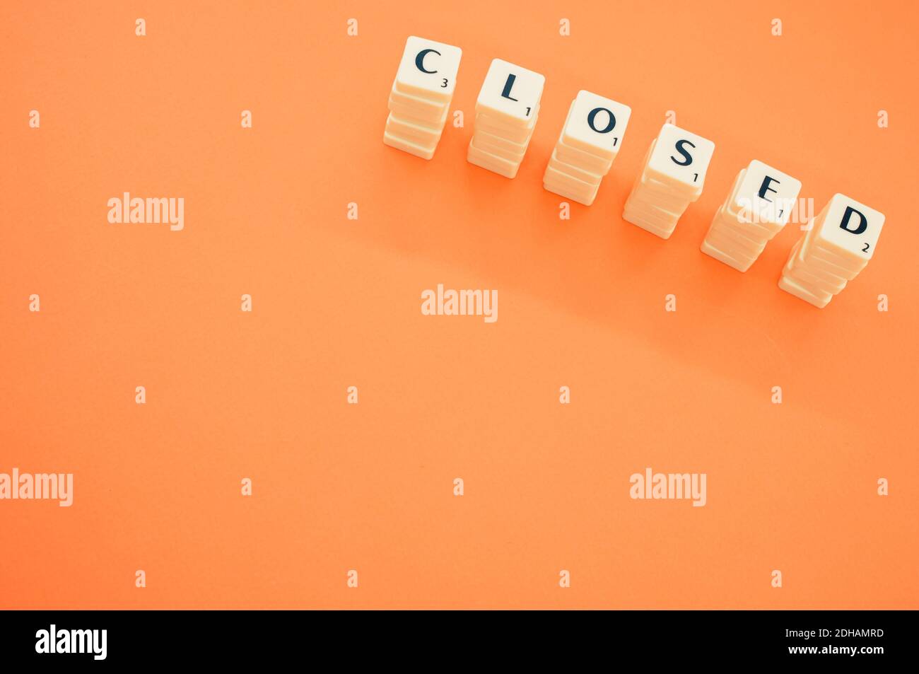 The six white letter block stacks forming the word CLOSED on orange ...