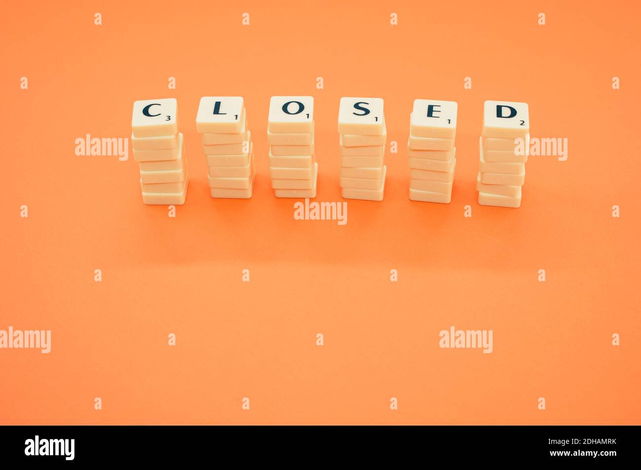The six white letter block stacks forming the word CLOSED on orange ...