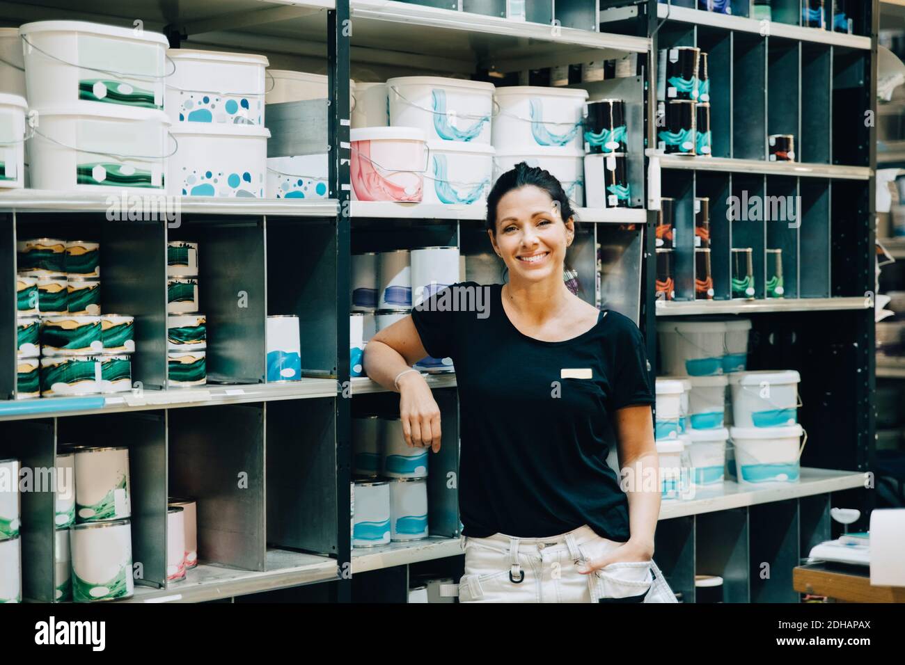 Portrait of smiling sales woman standing in hardware store Stock Photo ...