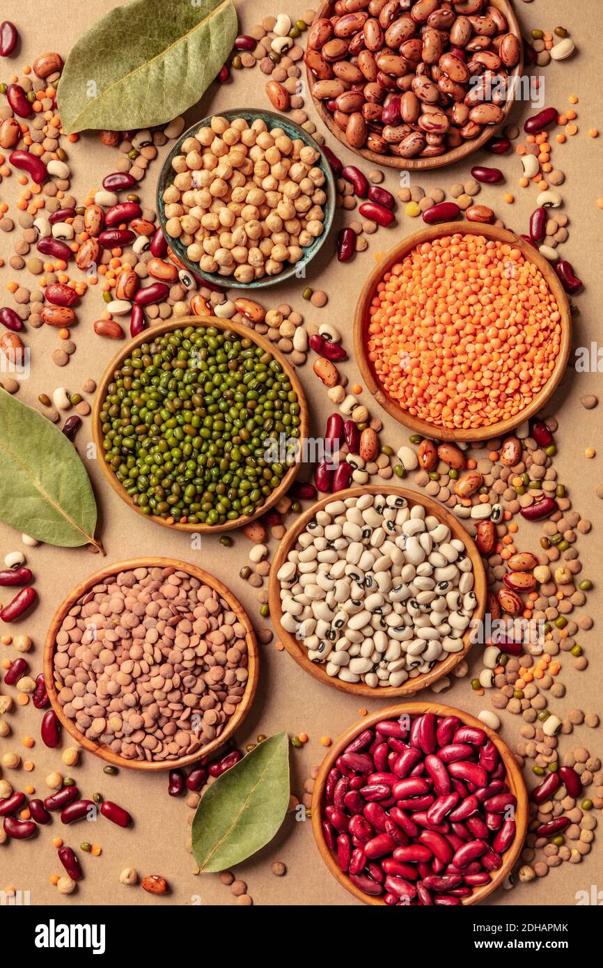 Various legumes, top shot on a brown background. Lentils, soybeans ...