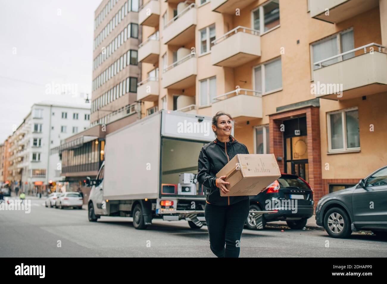 Person carrying box walking hi-res stock photography and images - Alamy
