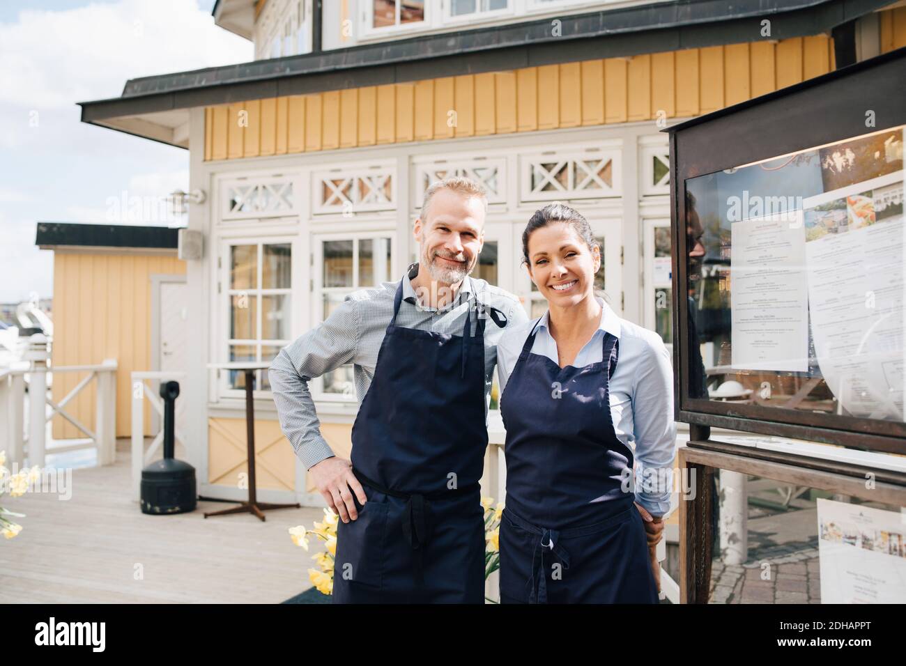 Portrait of smiling owners outside of restaurant Stock Photo - Alamy