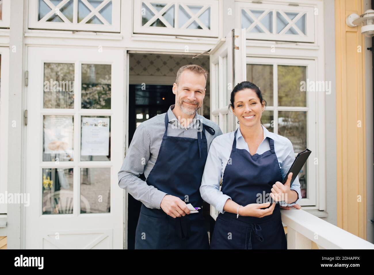 Male and female restaurant owners standing outdoors Stock Photo - Alamy
