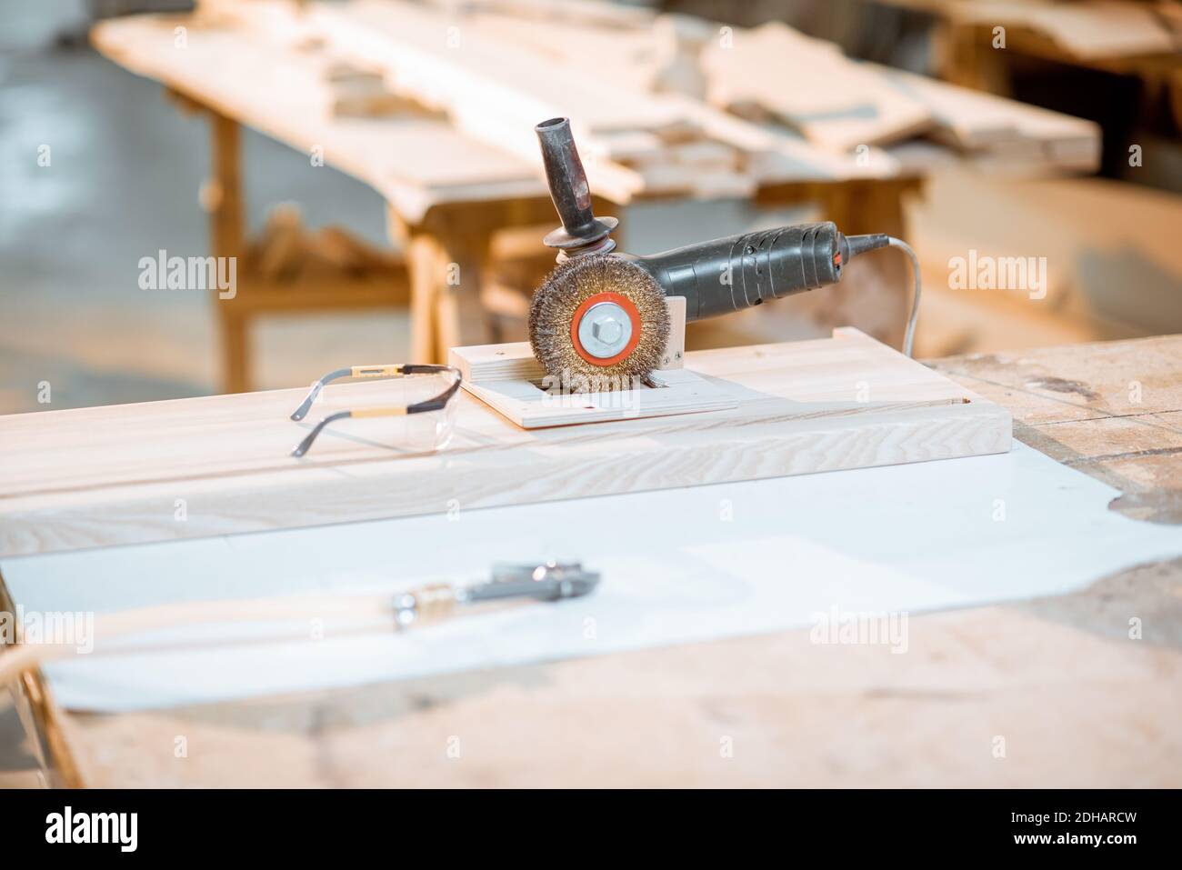 Brushing and grinding hand machine on the wooden product at the ...