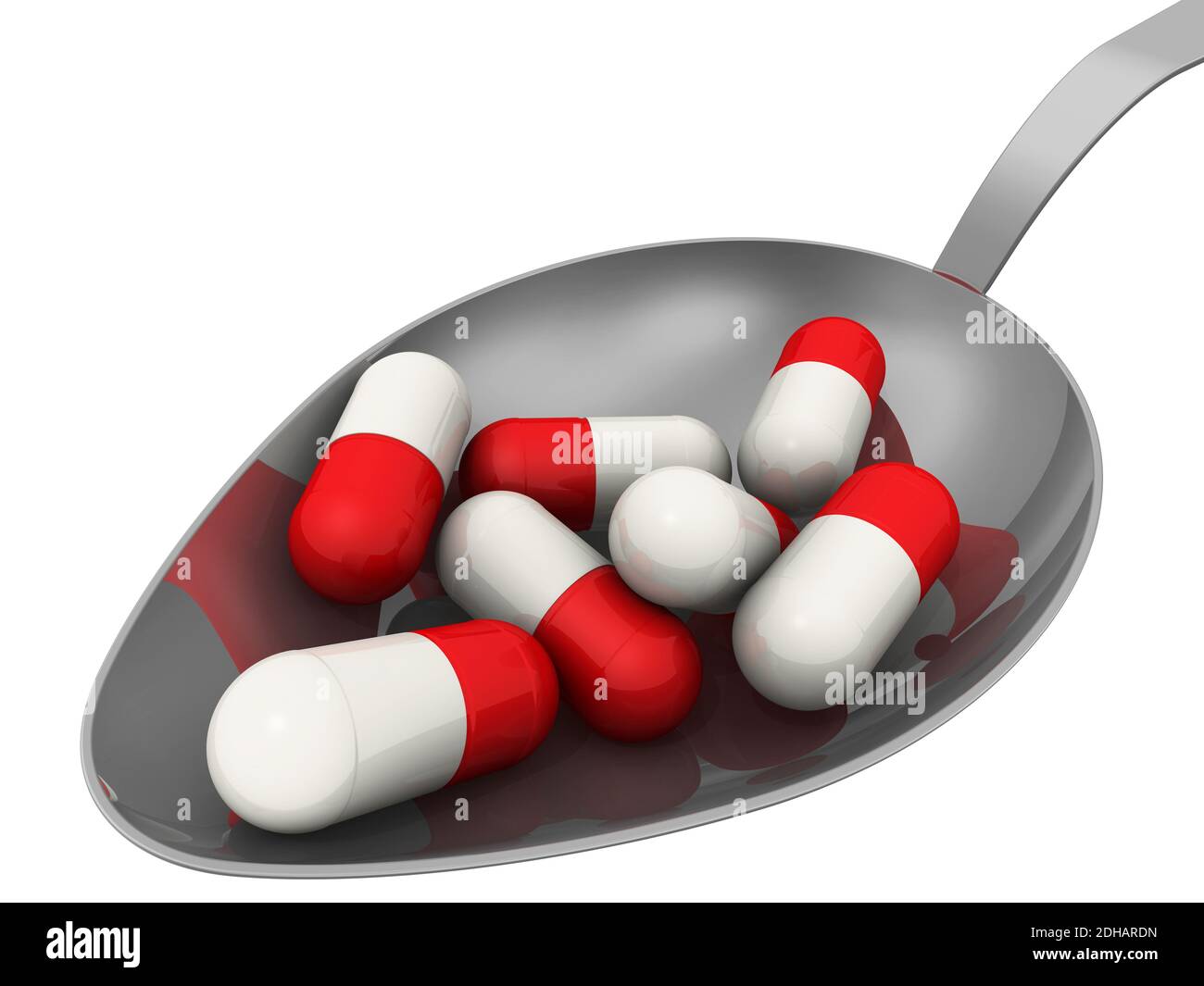 Medical capsules in a spoon. Red and white medical capsules in a spoon ...