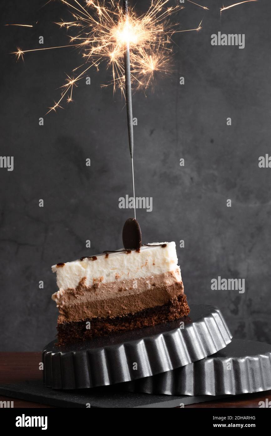 Piece of cake with sparkle lights, festive celebration concept Stock ...