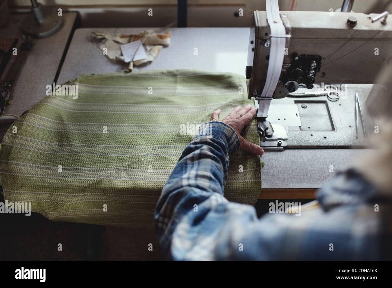Seamstress working on green fabric hi-res stock photography and images ...