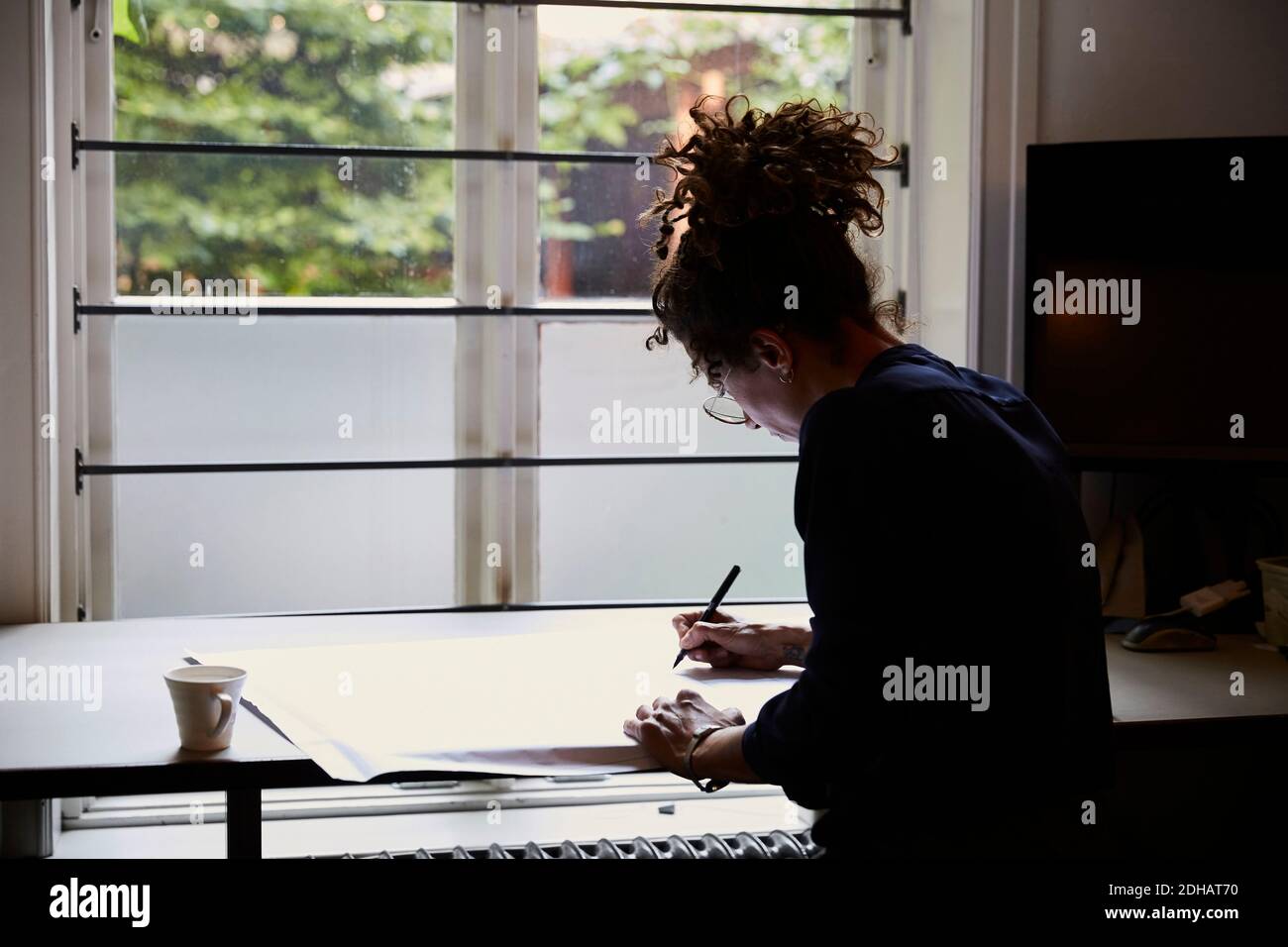 Side view of confident female architect planning in office Stock Photo ...