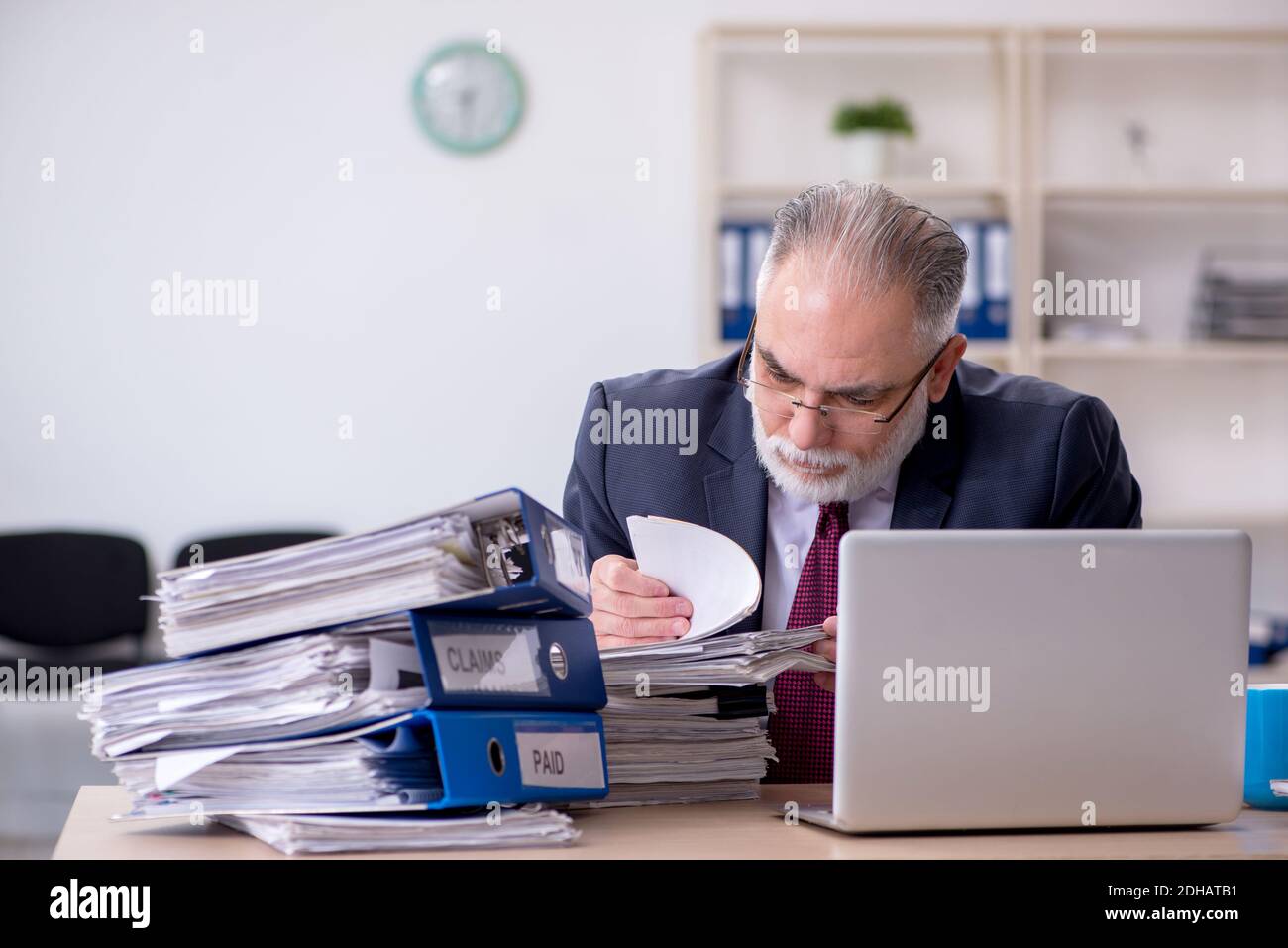 Aged male employee unhappy with excessive work Stock Photo - Alamy