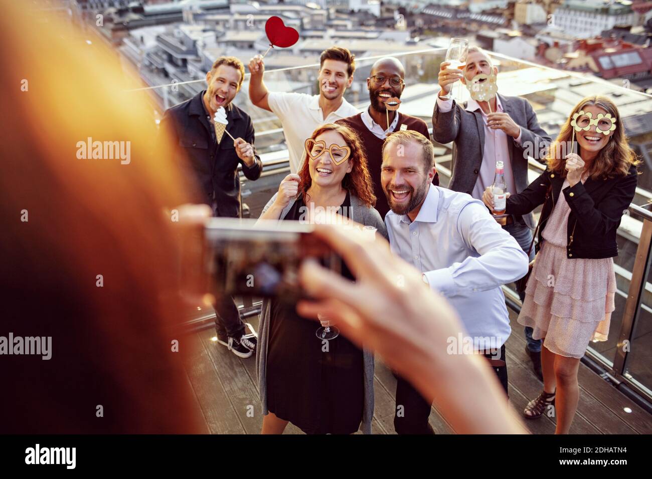 Happy colleagues posing while professional photographing at office ...