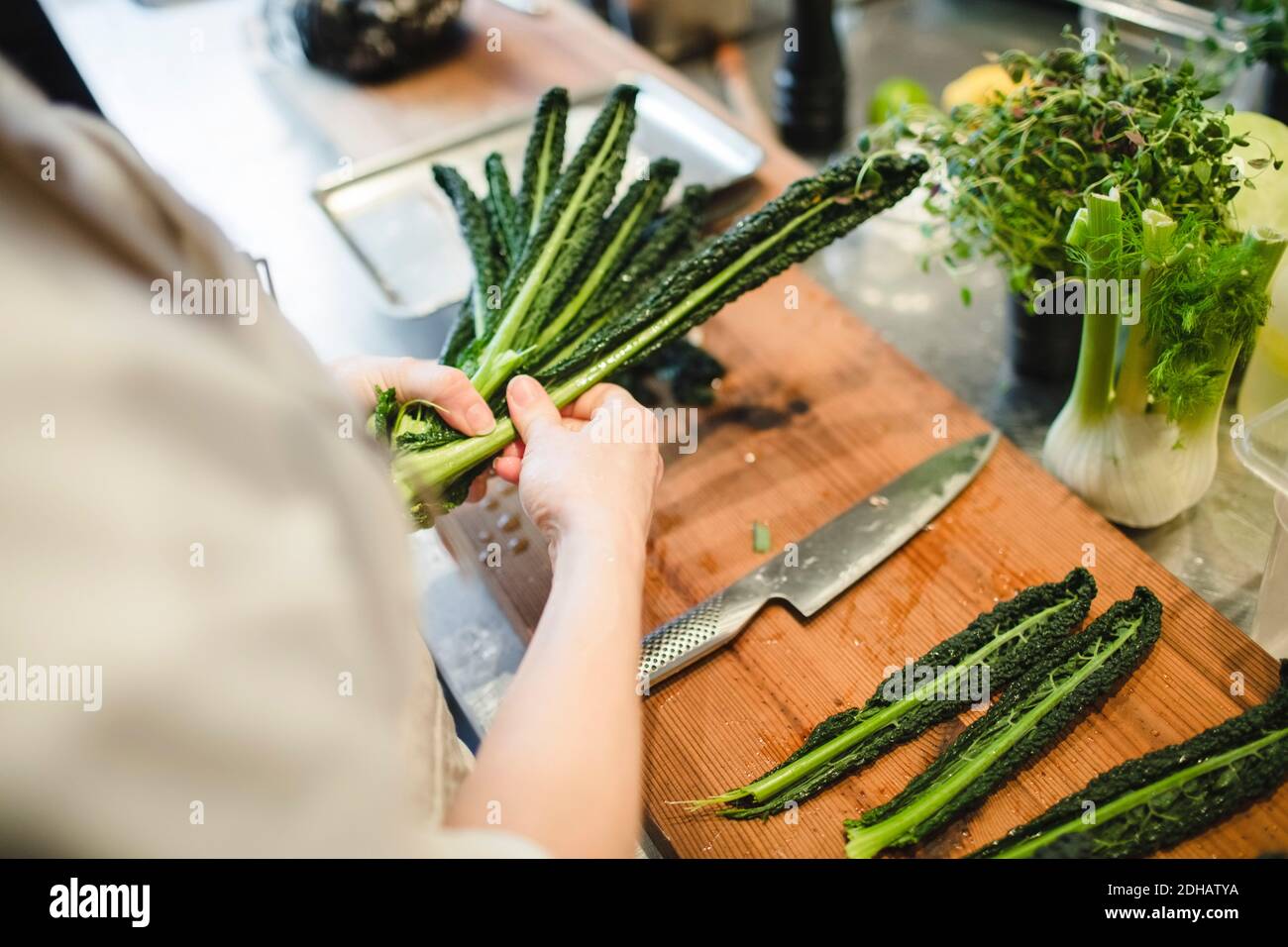 Midsection of female chef preparing vegetable at kitchen Stock Photo ...