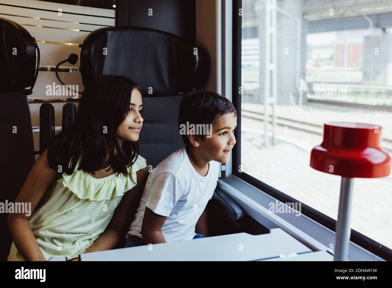 Girls looking through window train hi-res stock photography and images ...