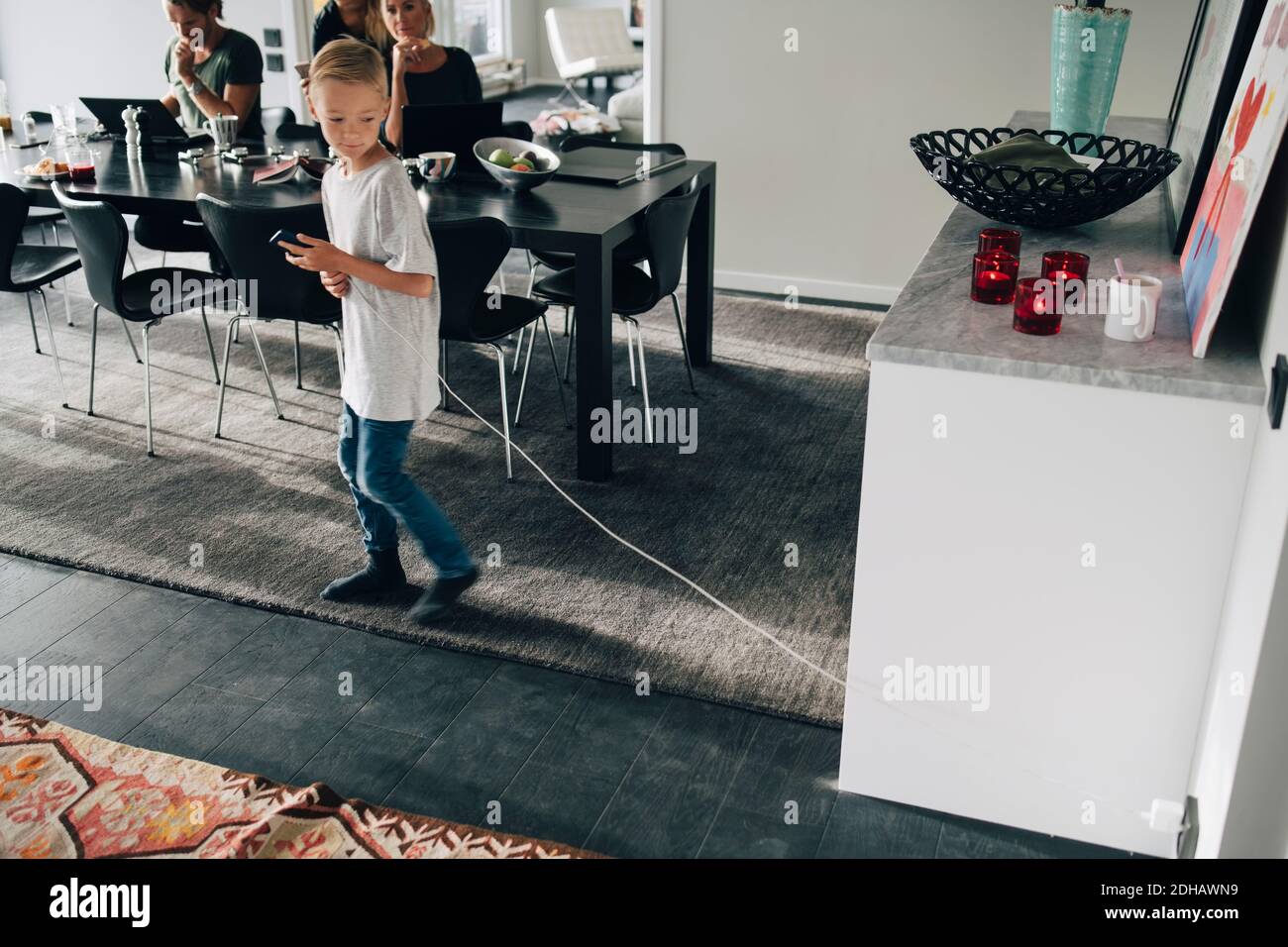 Mother pulling boy sitting hi-res stock photography and images - Alamy