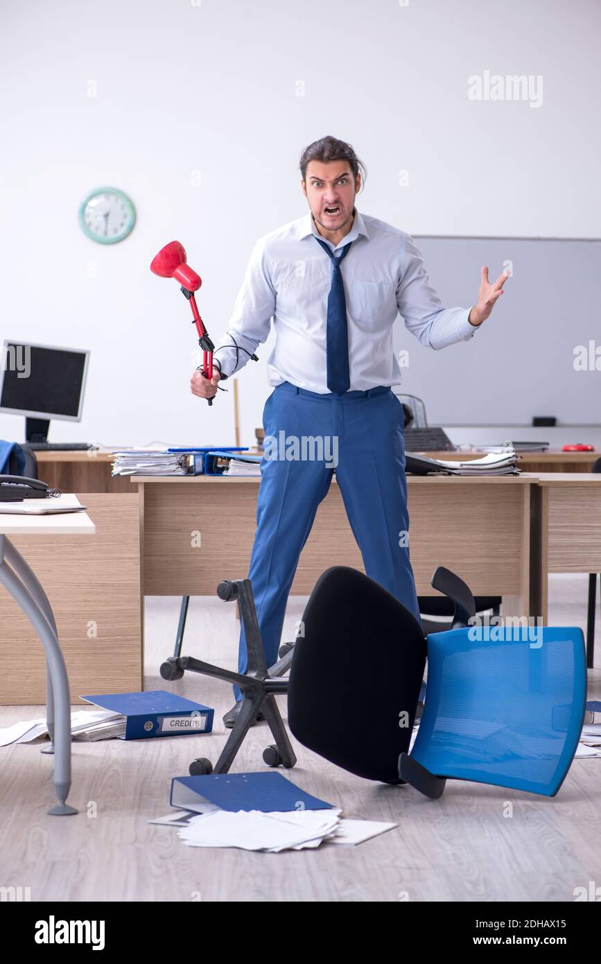 Angry male employee destroying hi-res stock photography and images - Alamy