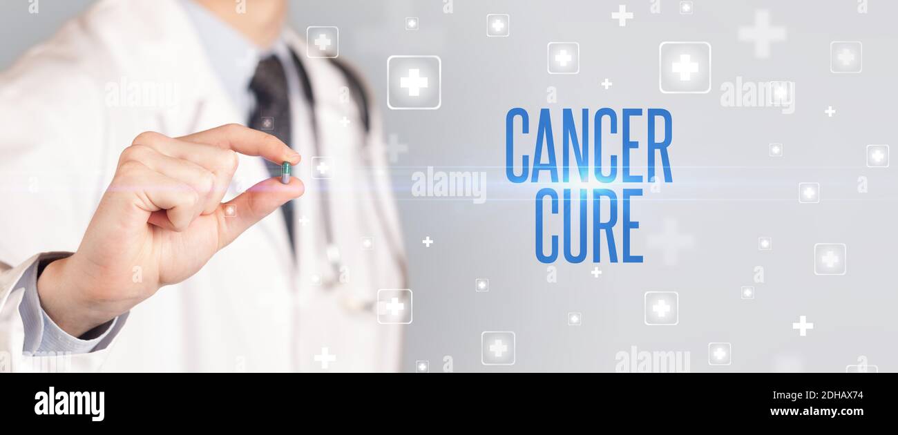 Close-up of a doctor giving a pill with CANCER CURE inscription ...