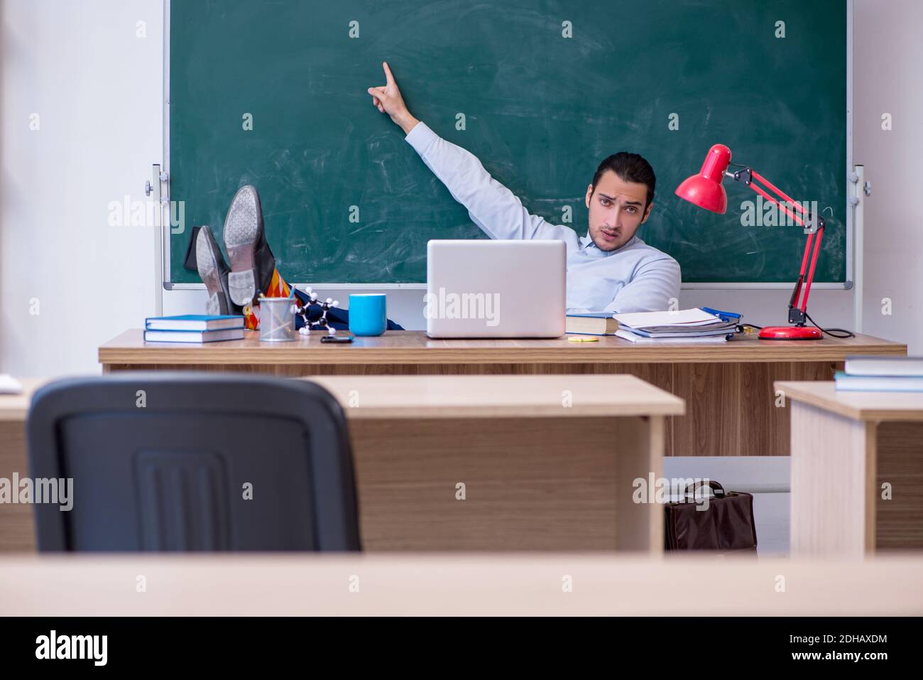 Male teacher pointing to board hi-res stock photography and images - Alamy
