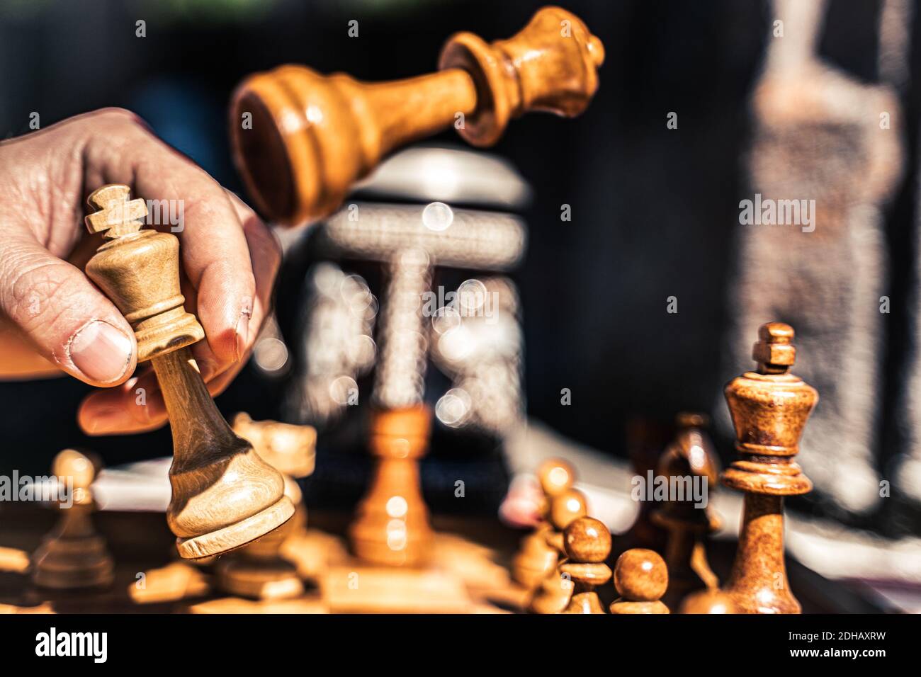 A selective focus shot of an old man hand holding the king - checkmate ...