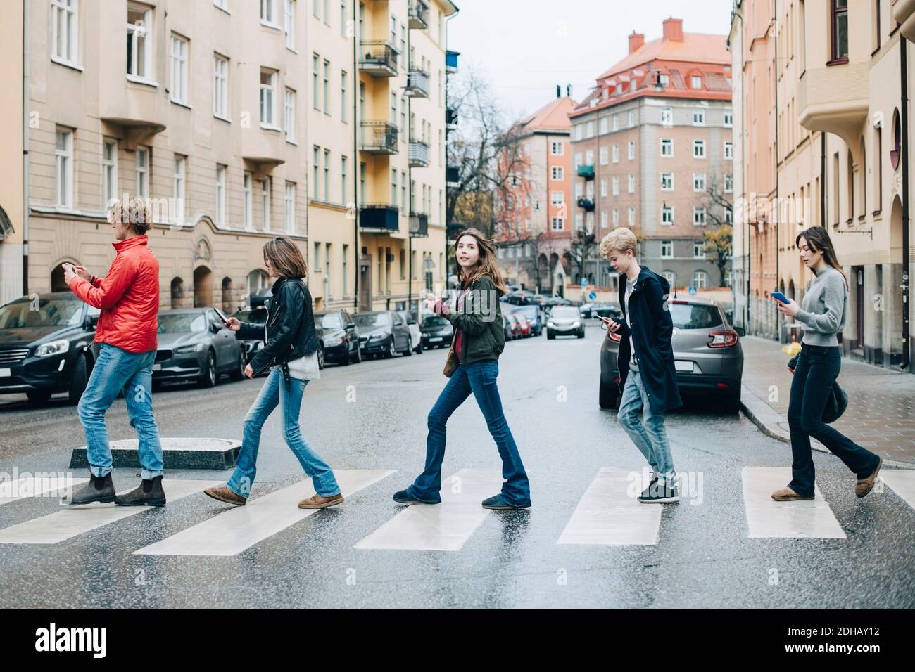 Teenager crossing street phone hi-res stock photography and images - Alamy