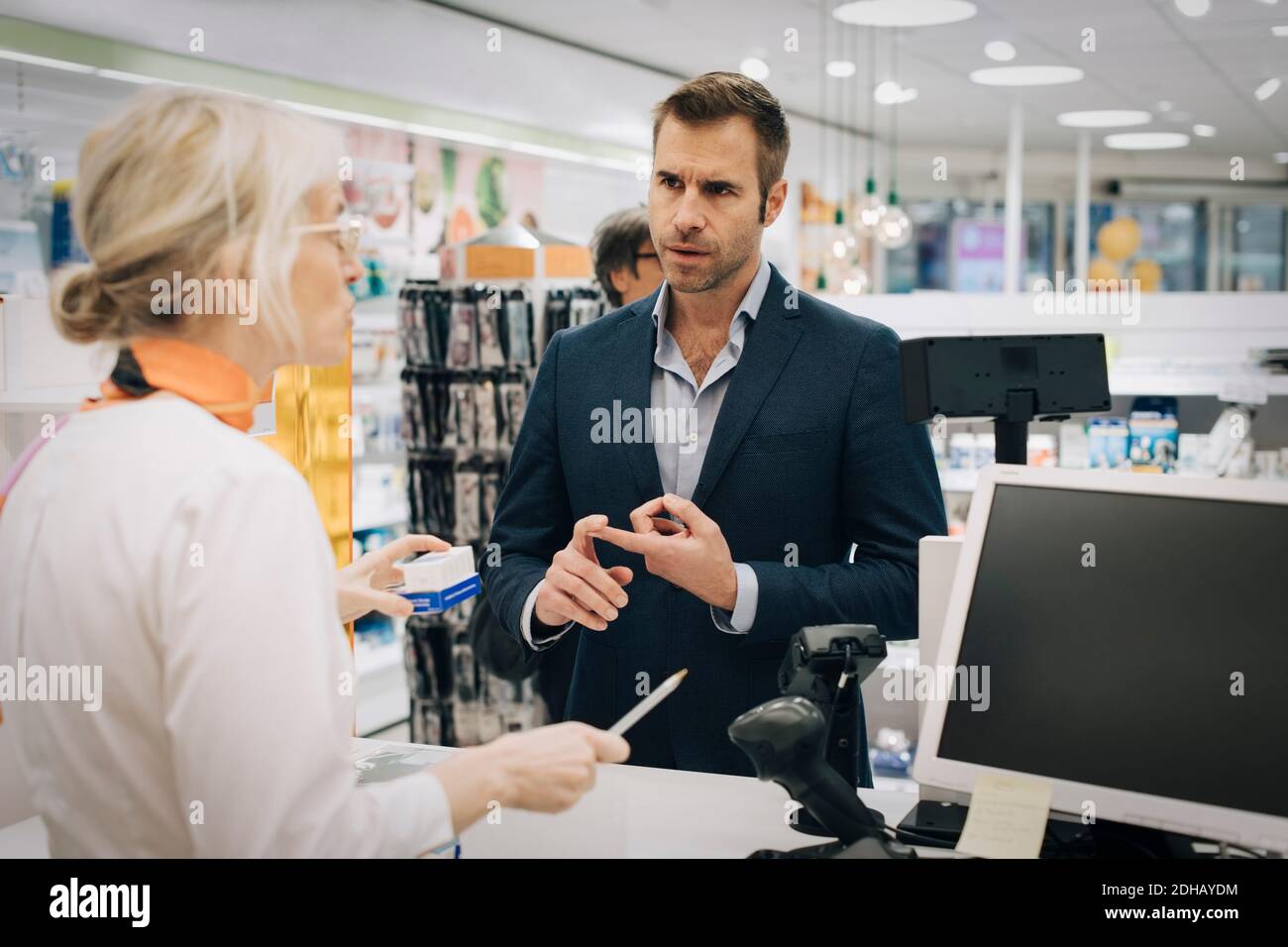 Mature man checkout female hi-res stock photography and images - Alamy