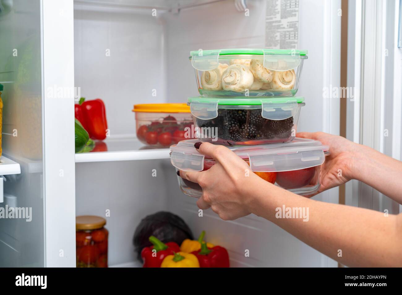 Female hands taking storage box with food from a fridge Stock Photo - Alamy
