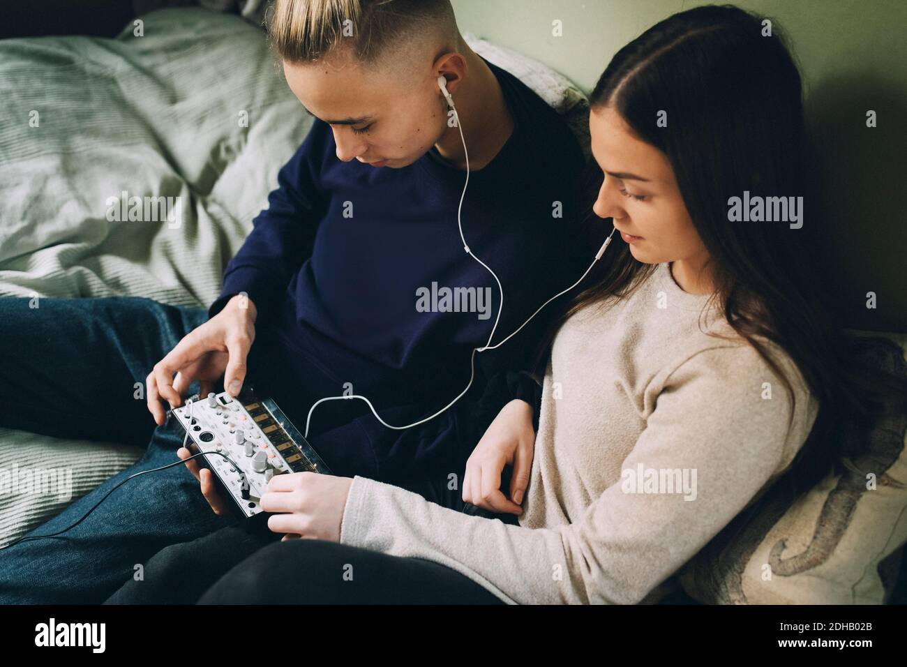 High angle view of teenage friends using sound mixer at bedroom Stock ...