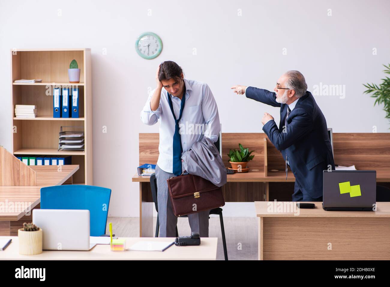 Old boss and his male secretary employee in time management conc Stock ...