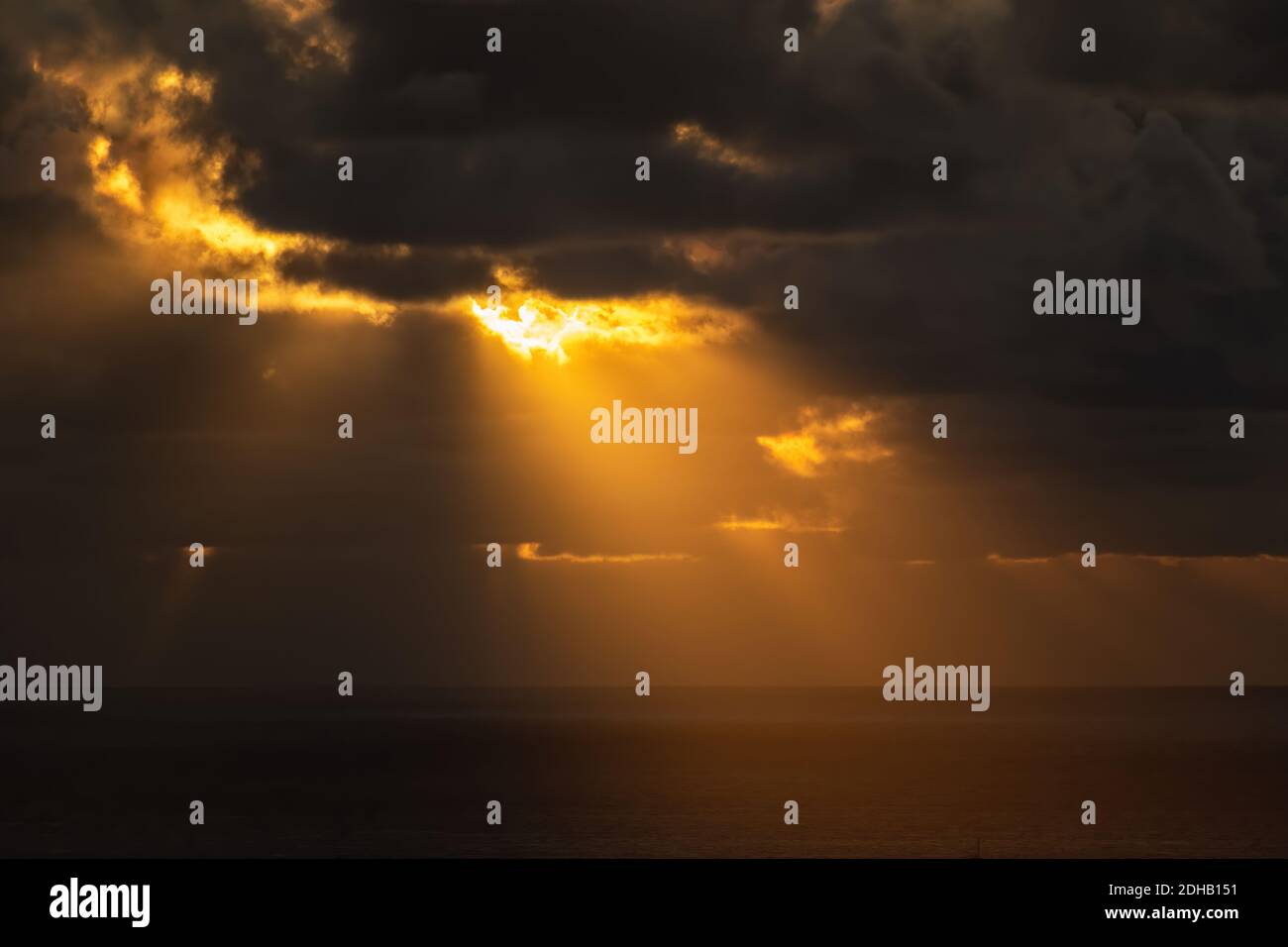 Aerial view of evening sun hiding behind group of dark clouds Stock ...