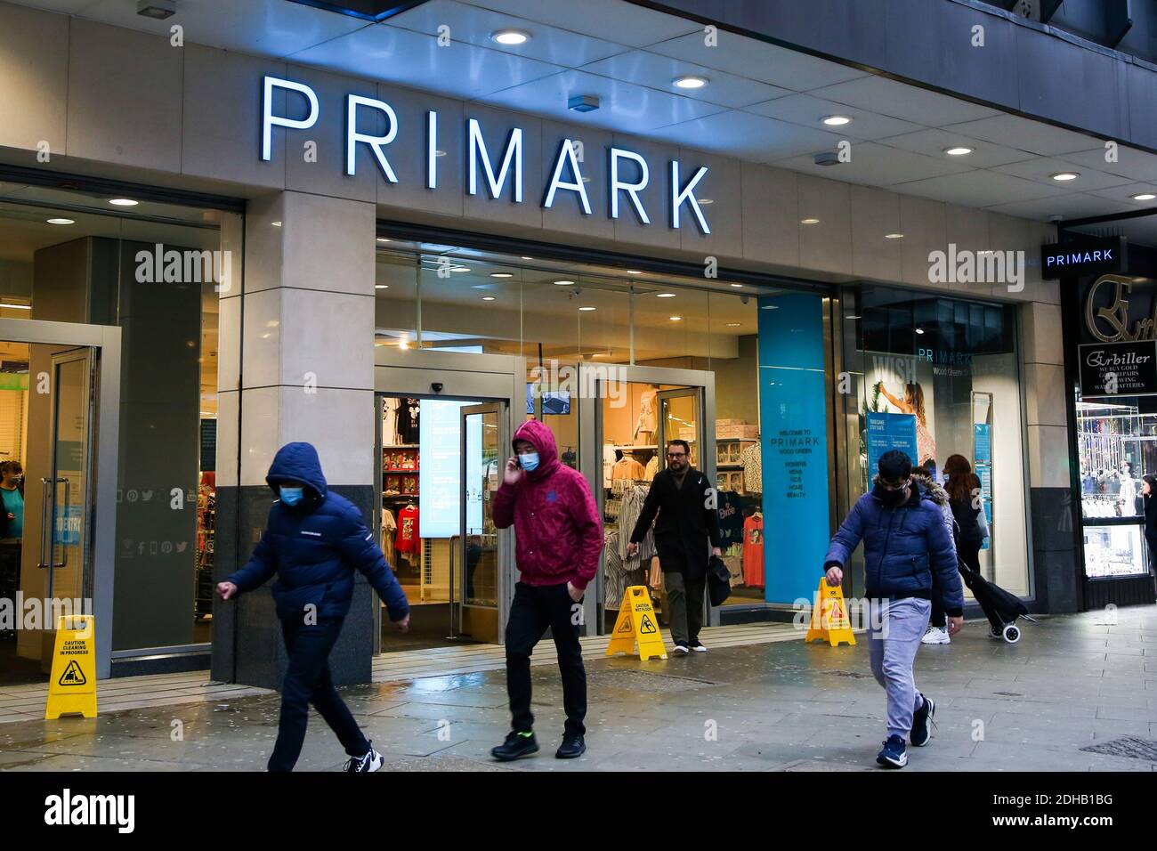 London, UK. 10th Dec, 2020. People wearing face masks walk past a ...